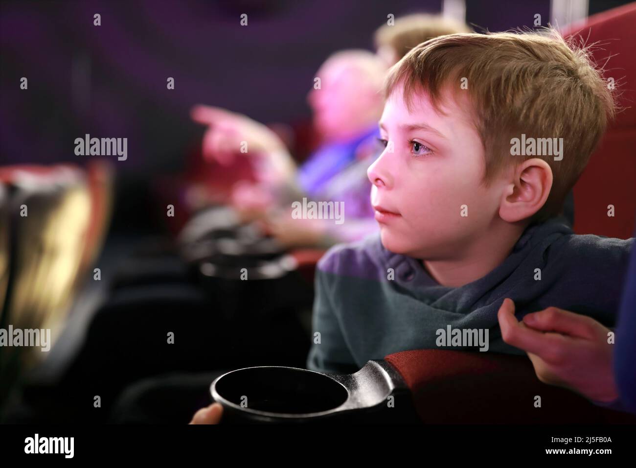 Portrait of child watching movie in cinema Stock Photo - Alamy