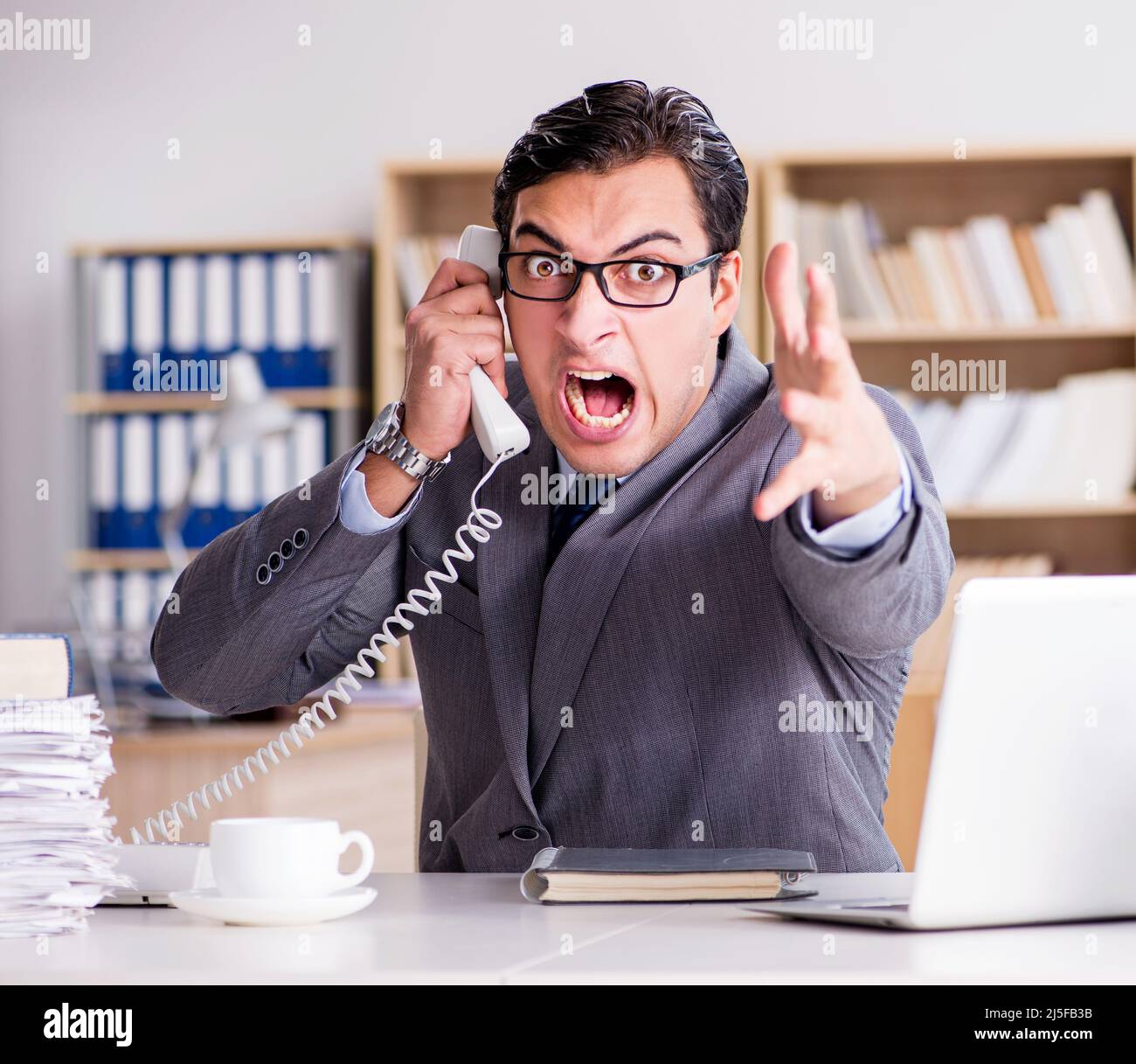 The angry businessman with too much work in office Stock Photo - Alamy