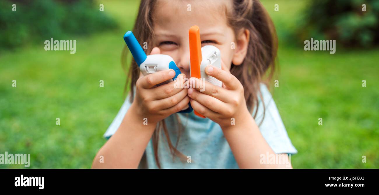 Small girl,kid play in walkie-talkie.Walkie Talkies with channels.Game ...