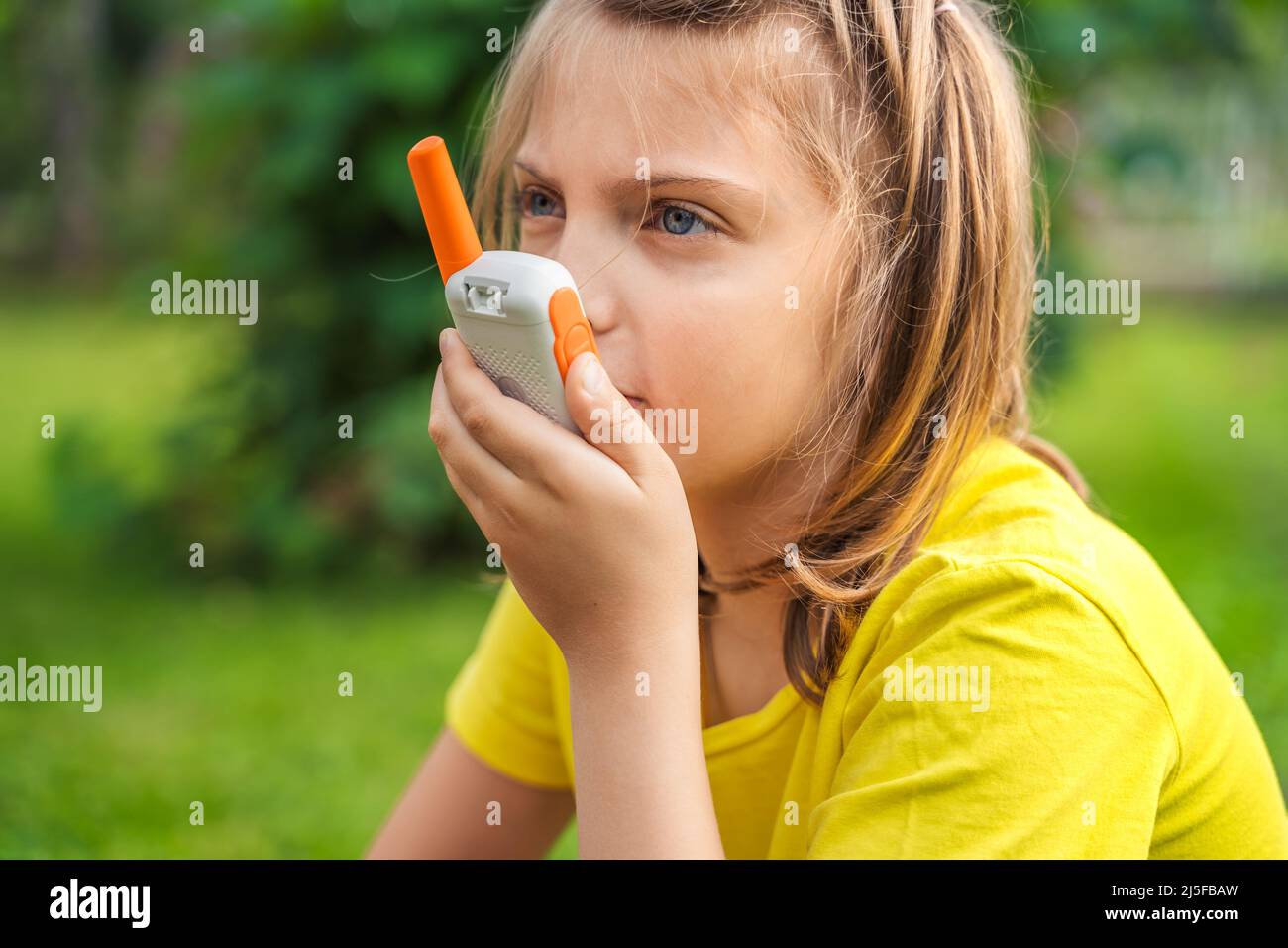 Small girl,kid play in walkie-talkie.Walkie Talkies with channels.Game ...