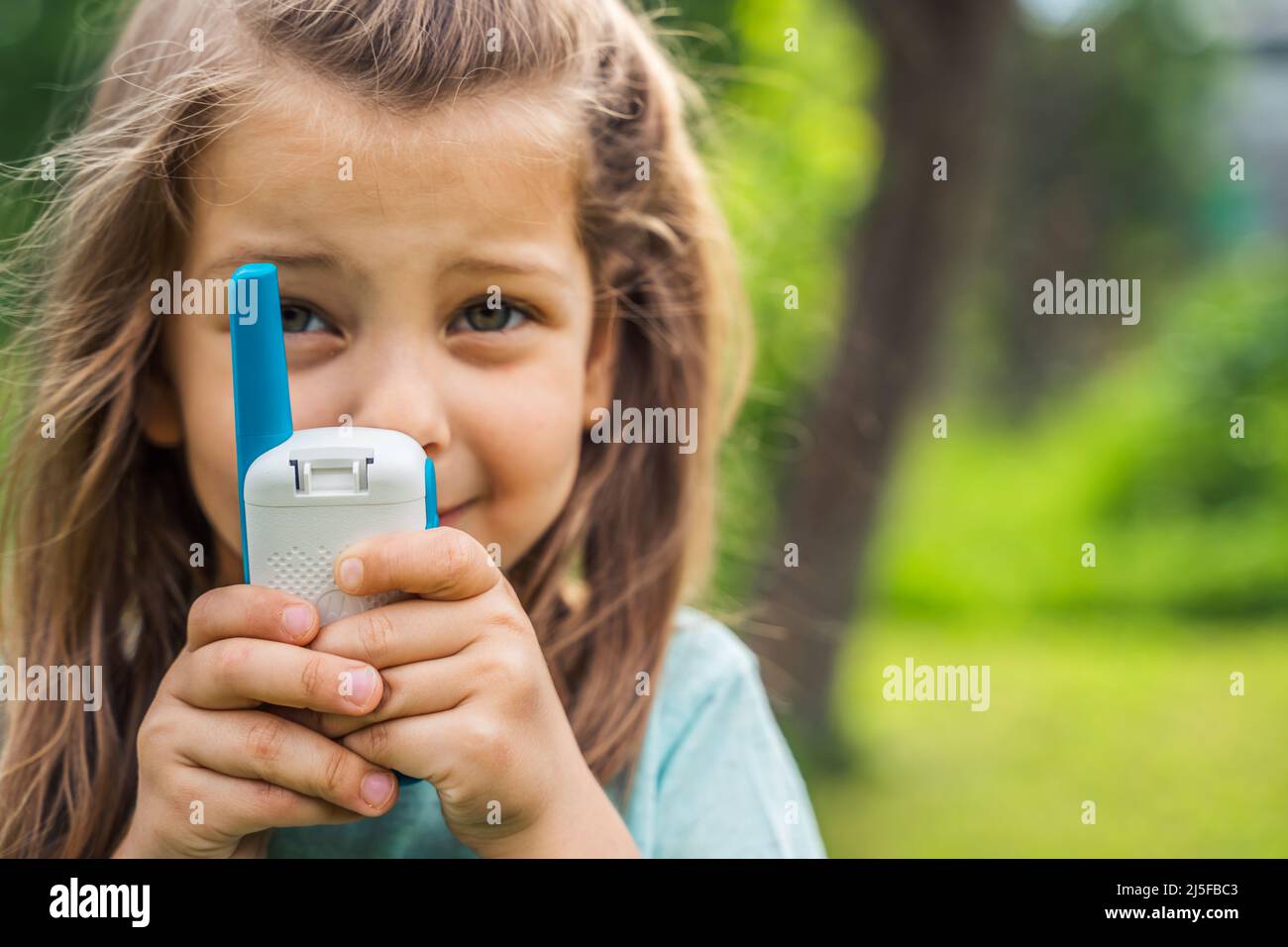 Small girl,kid play in walkie-talkie.Walkie Talkies with channels.Game ...