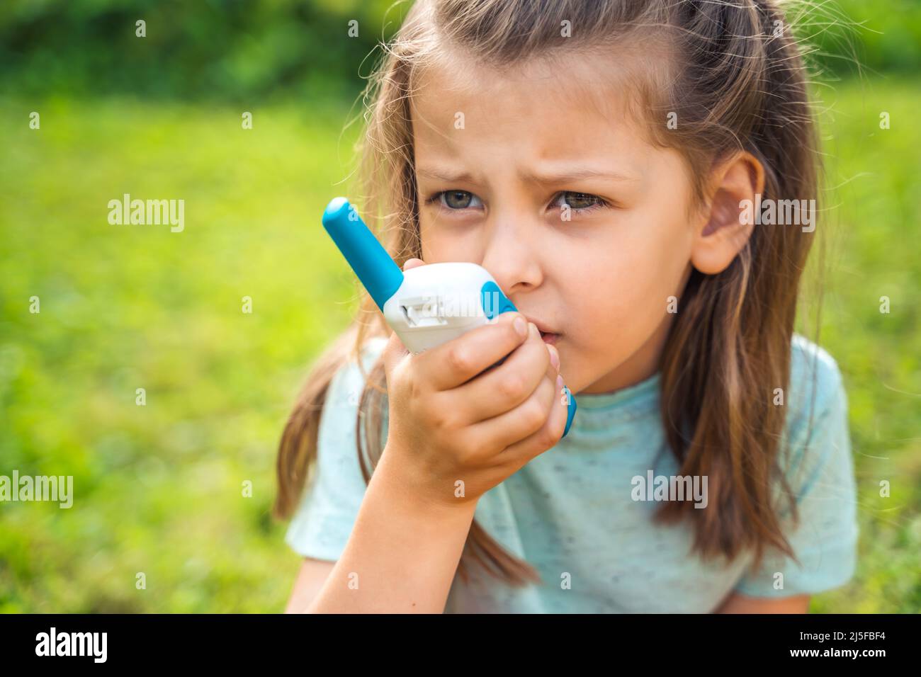 Small girl,kid play in walkie-talkie.Walkie Talkies with channels.Game ...