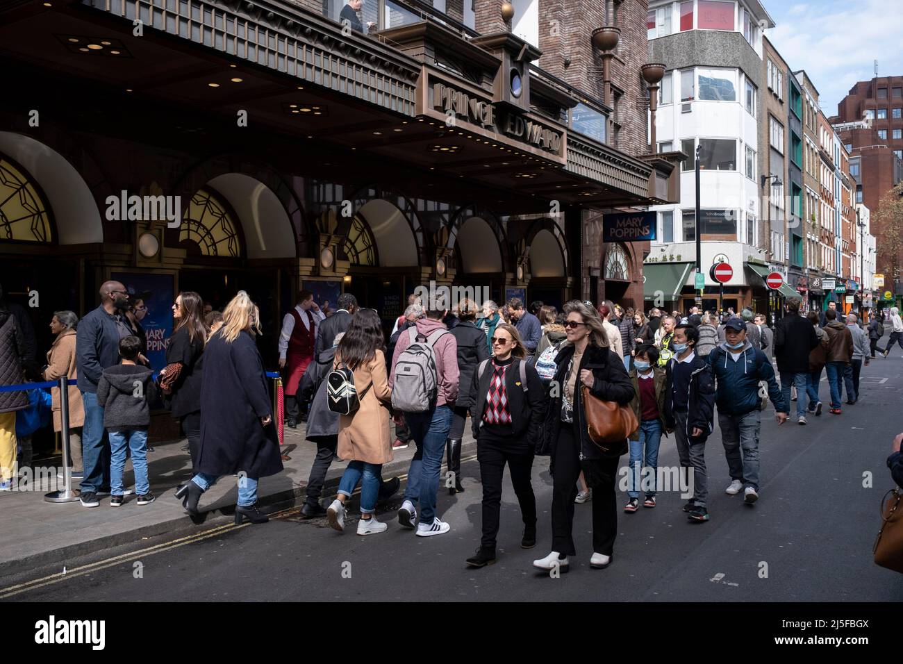 Theatre-goes queue up outside the Prince Edward Theatre in Soho which ...