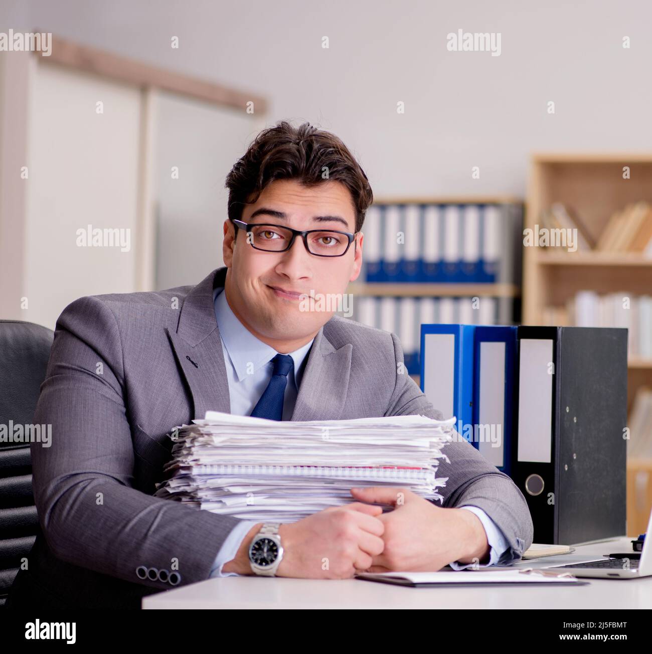 The businessman with too much paperwork Stock Photo - Alamy