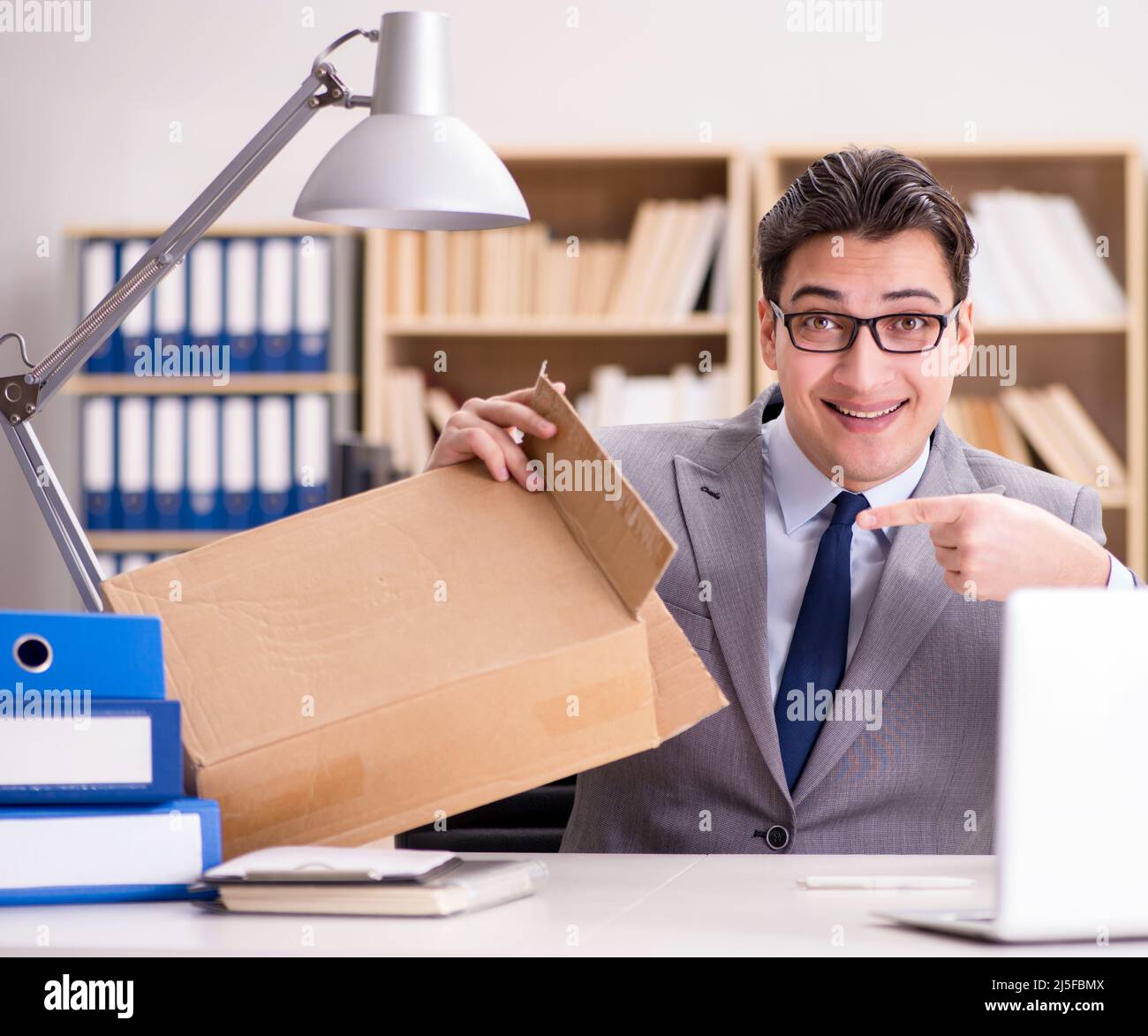 The businessman receiving parcel in the office Stock Photo - Alamy