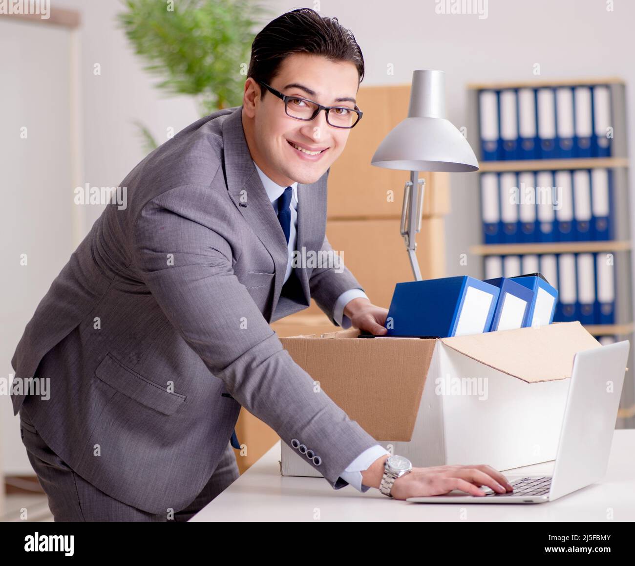 The businessman moving offices after promotion Stock Photo - Alamy