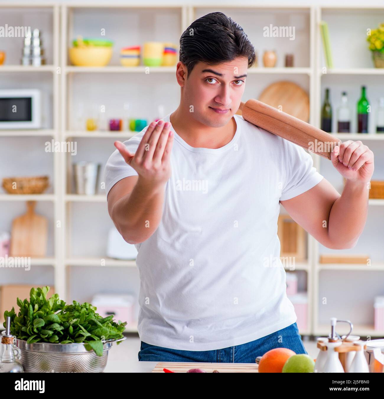 The young male cook working in the kitchen Stock Photo - Alamy