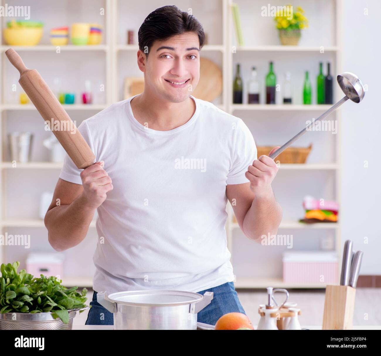 The young male cook working in the kitchen Stock Photo - Alamy