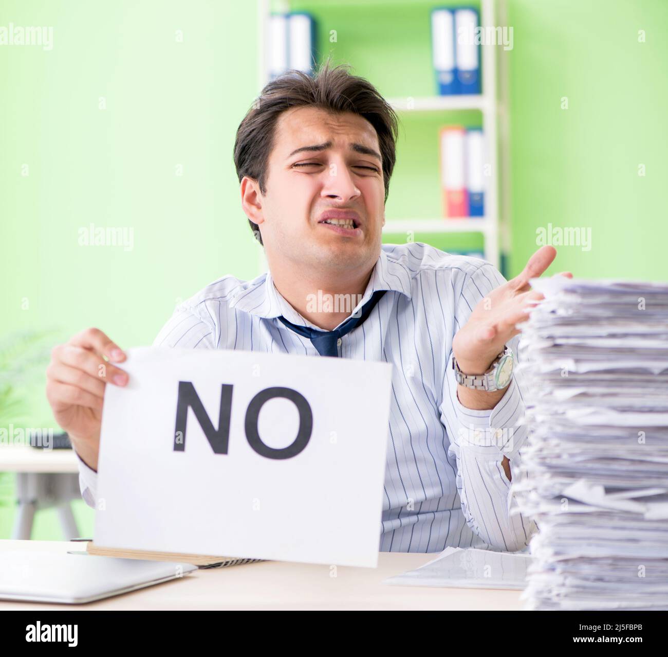 The businessman having problems with paperwork and workload Stock Photo ...
