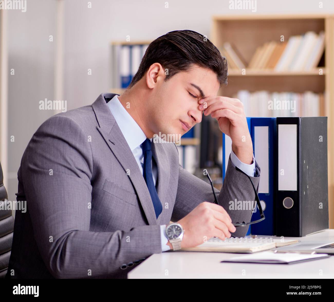 The sleepy businessman working in office Stock Photo - Alamy