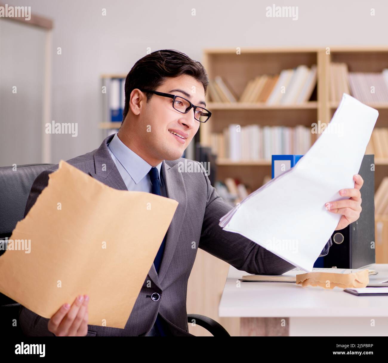 The businessman receiving letter envelope in office Stock Photo - Alamy