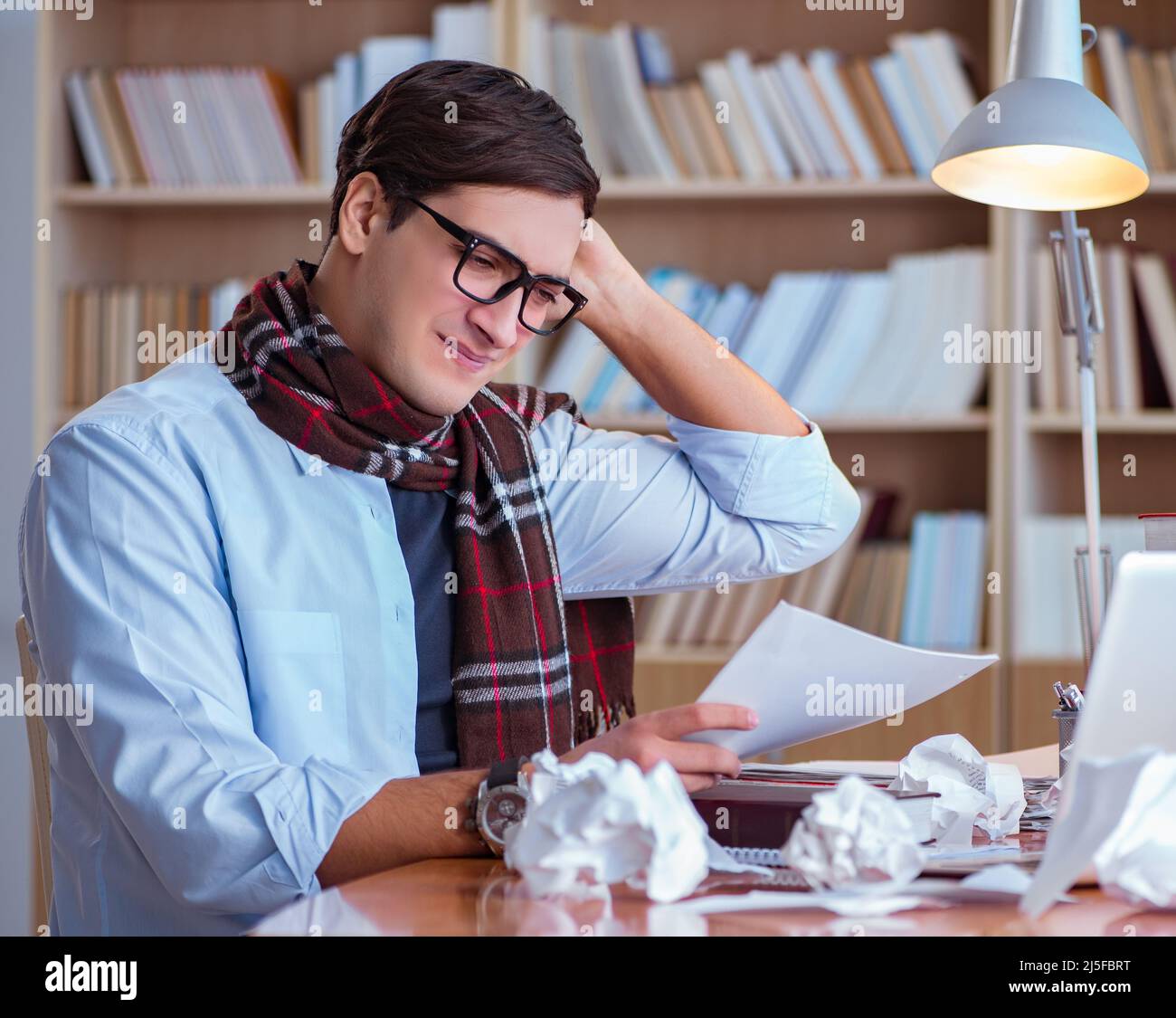 The young book writer writing in library Stock Photo - Alamy