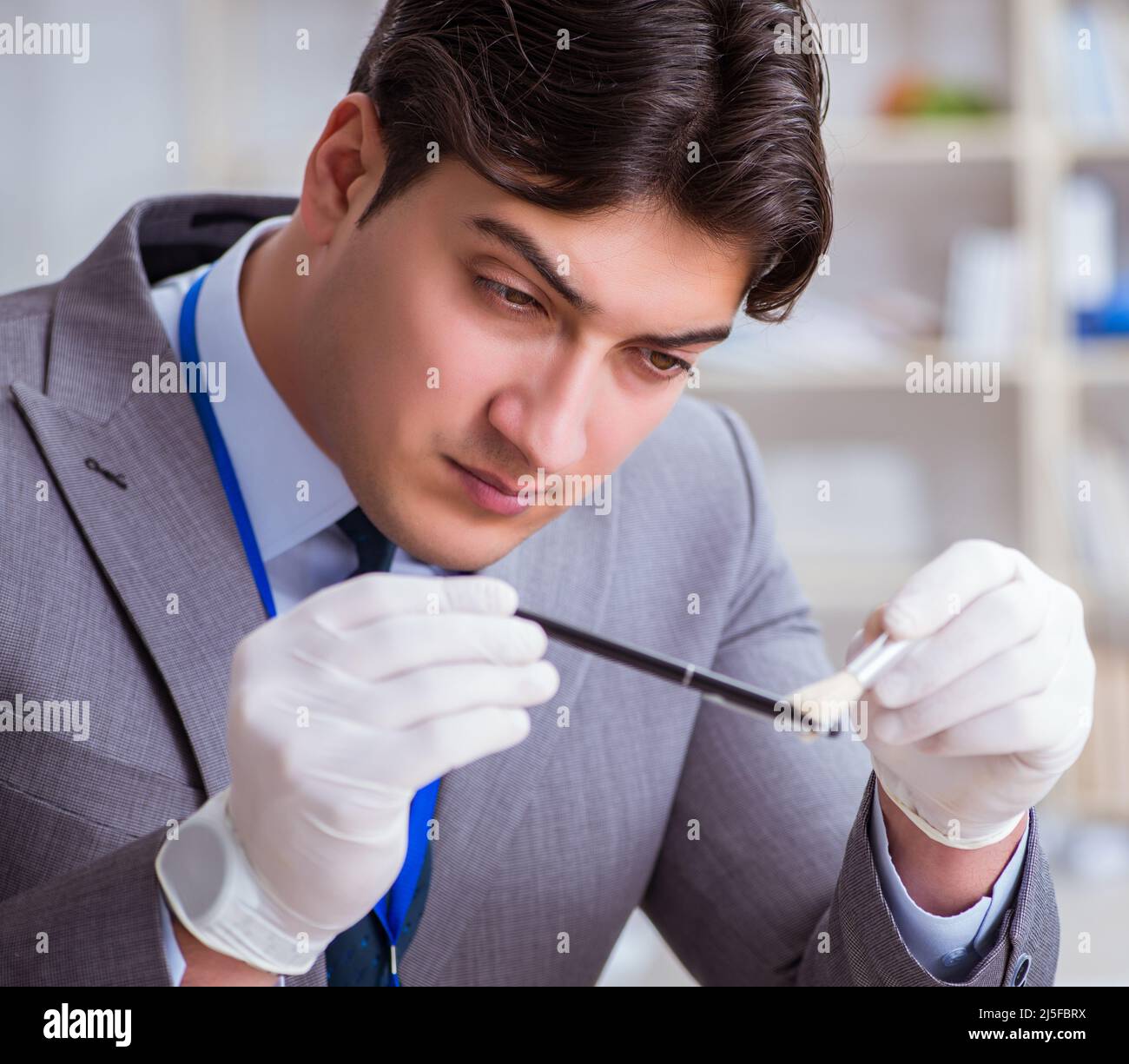 The young man during crime investigation in office Stock Photo - Alamy