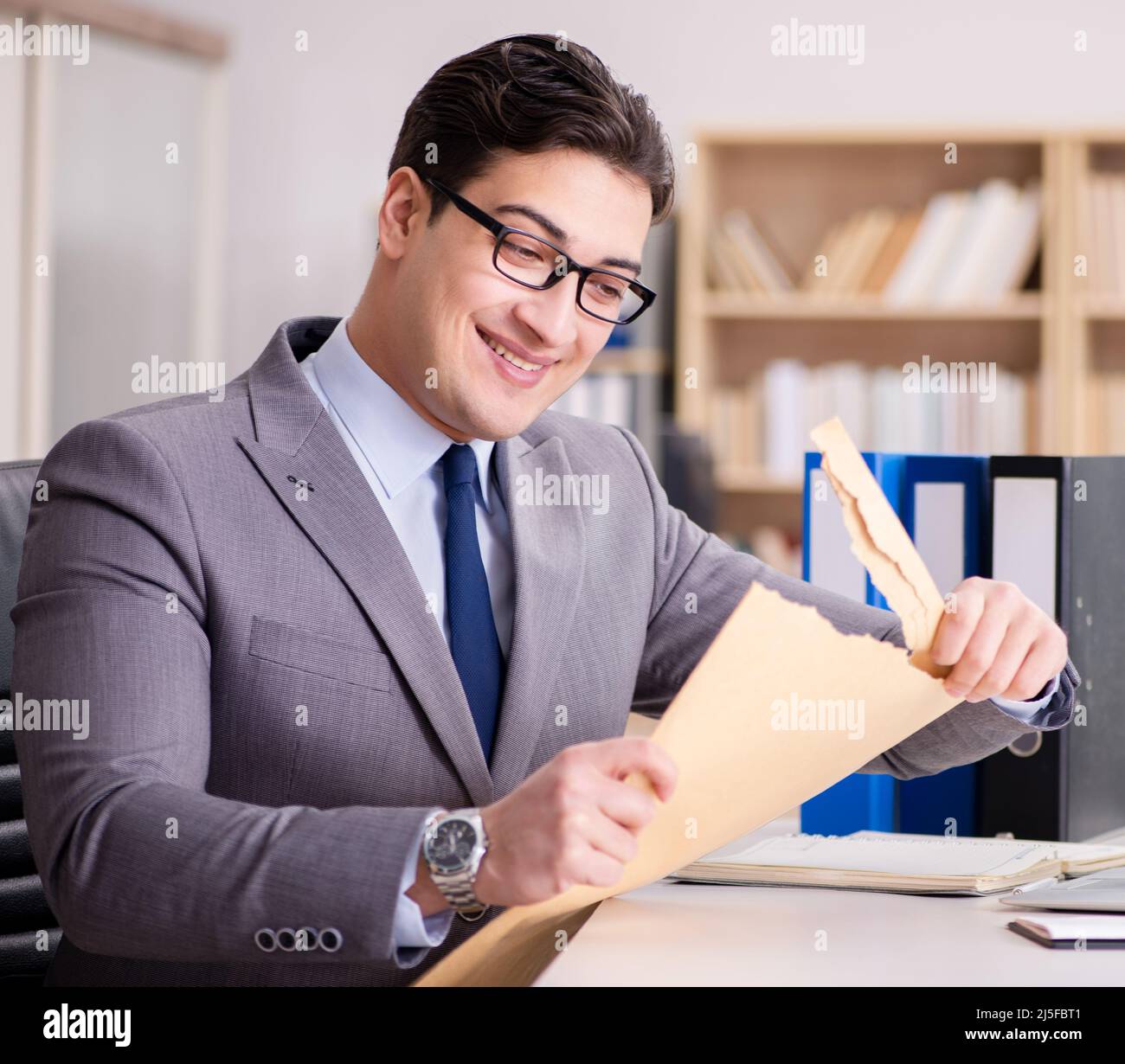 The businessman receiving letter in the office Stock Photo - Alamy