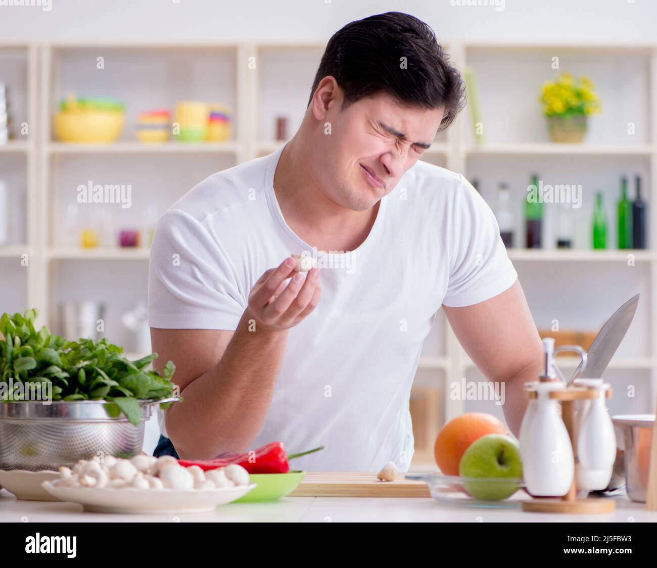 The young male cook working in the kitchen Stock Photo - Alamy