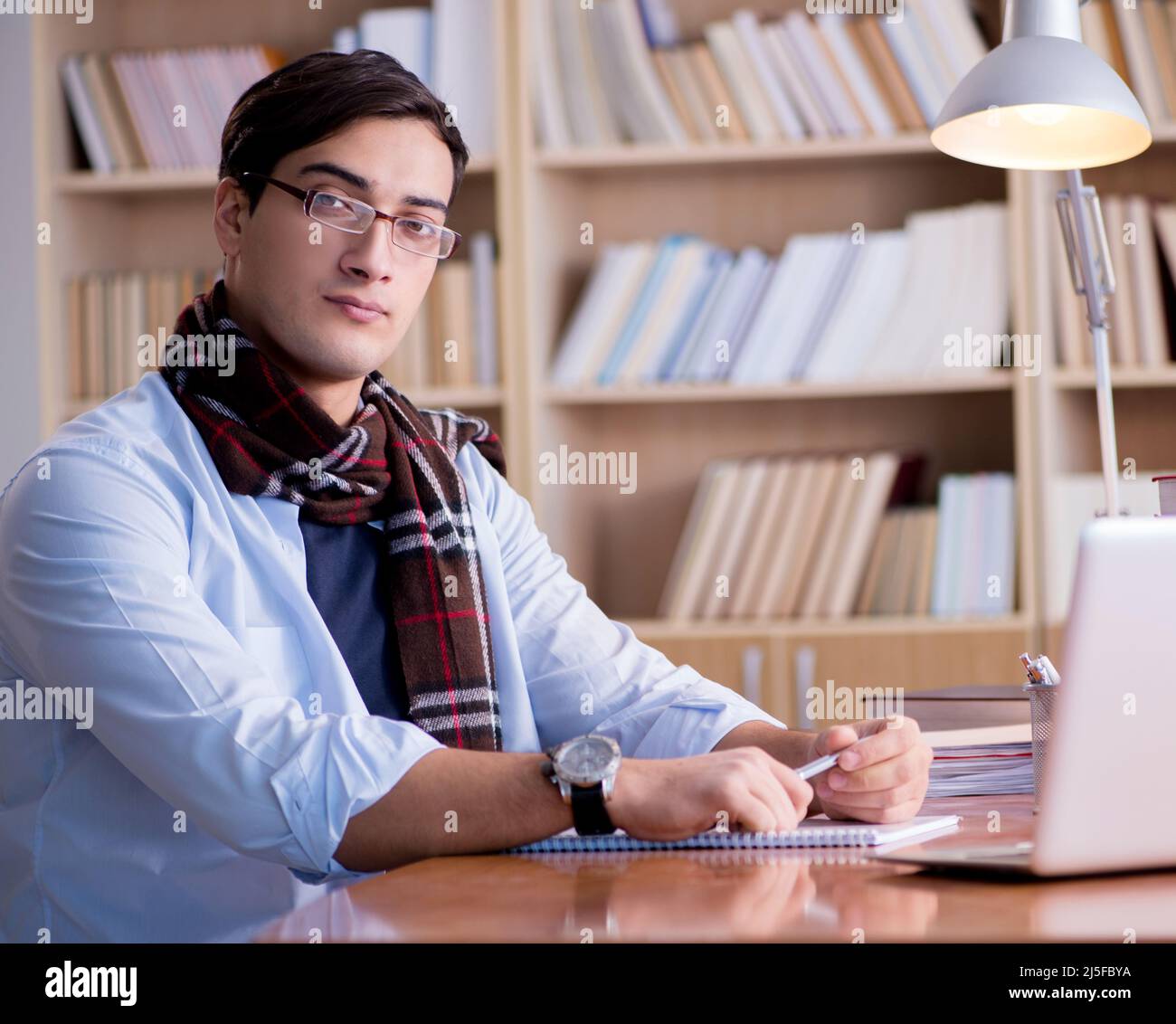 The young writer working in the library Stock Photo - Alamy