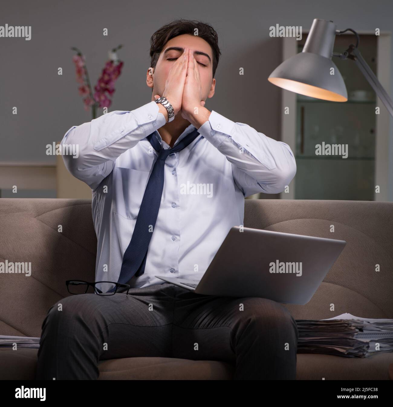 The businessman workaholic working late at home Stock Photo - Alamy
