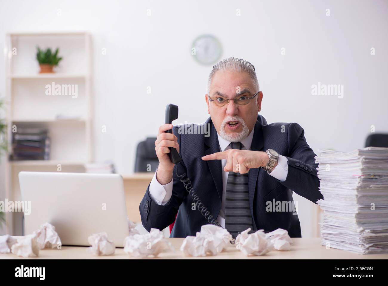 Old businessman employee in brainstorming concept Stock Photo - Alamy