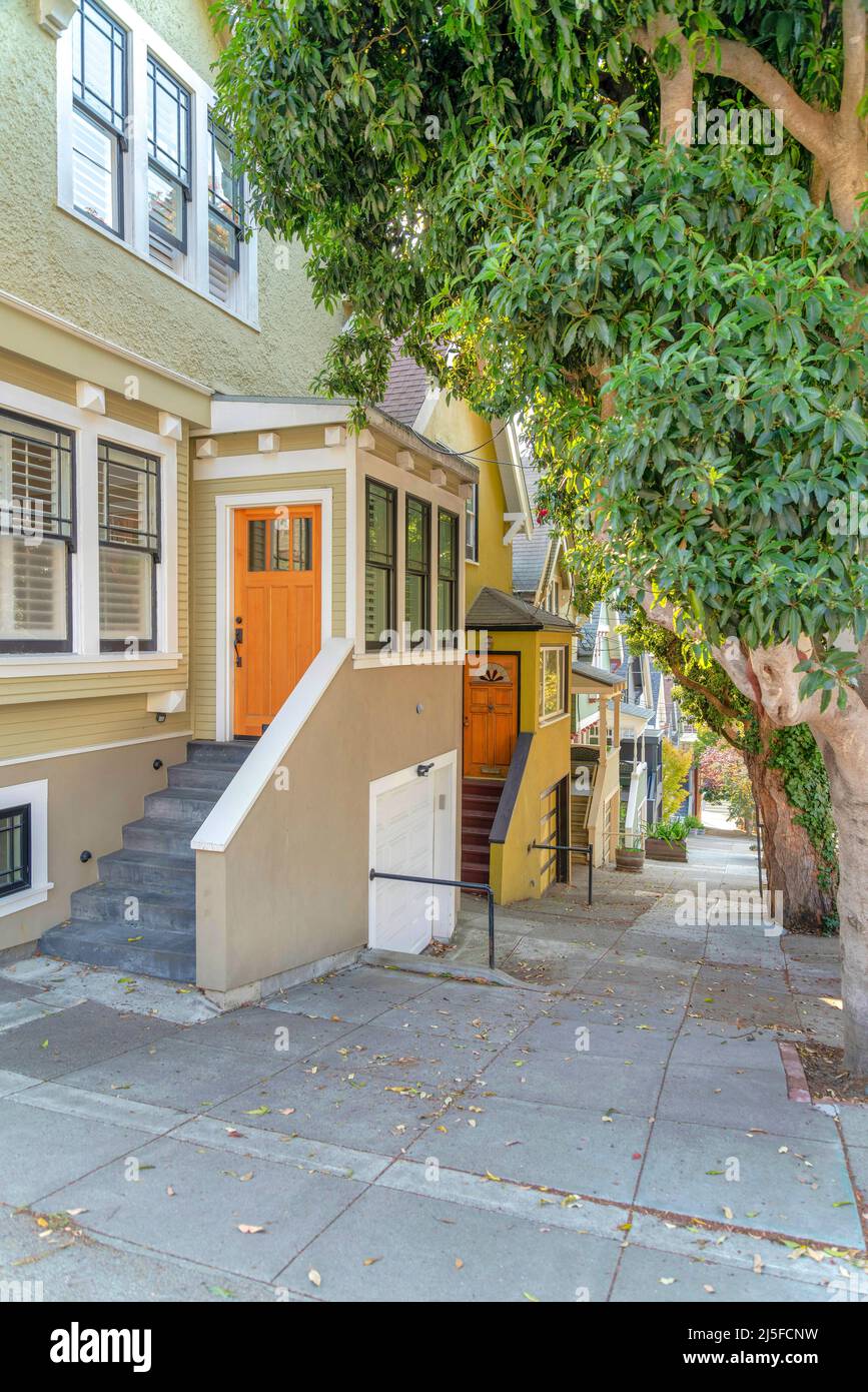 Houses on a slope downhill path at San Francisco, California. There are ...