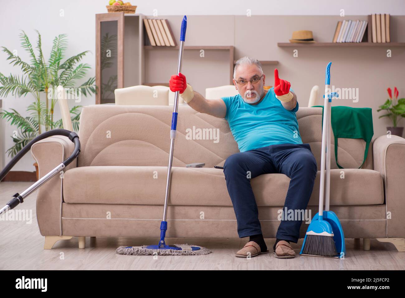 Aged man cleaning the house Stock Photo - Alamy