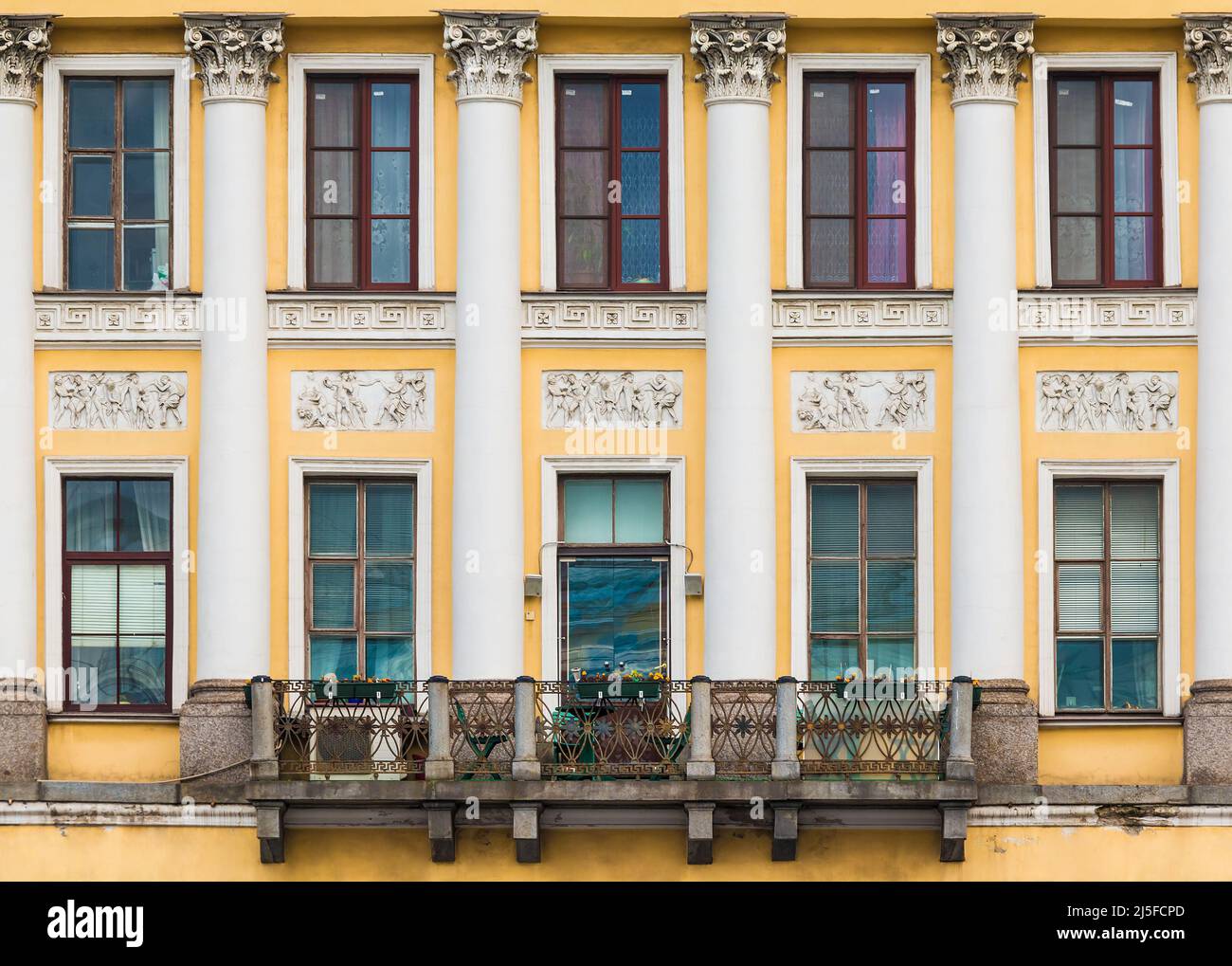 Balcony and many windows in a row on the facade of the urban historic ...