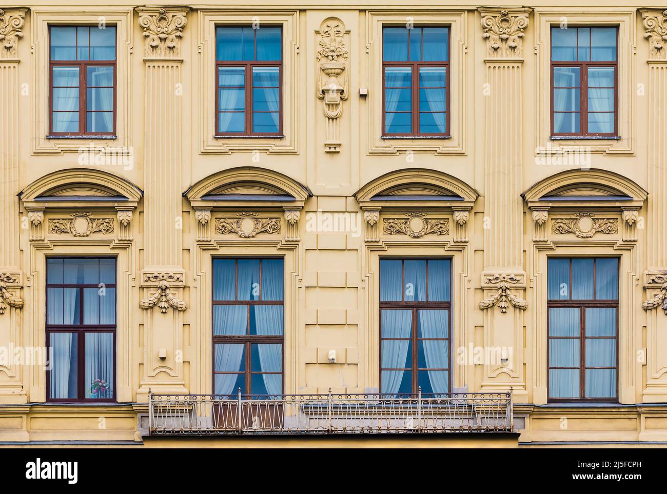 Balcony and several windows in a row on the facade of the urban ...