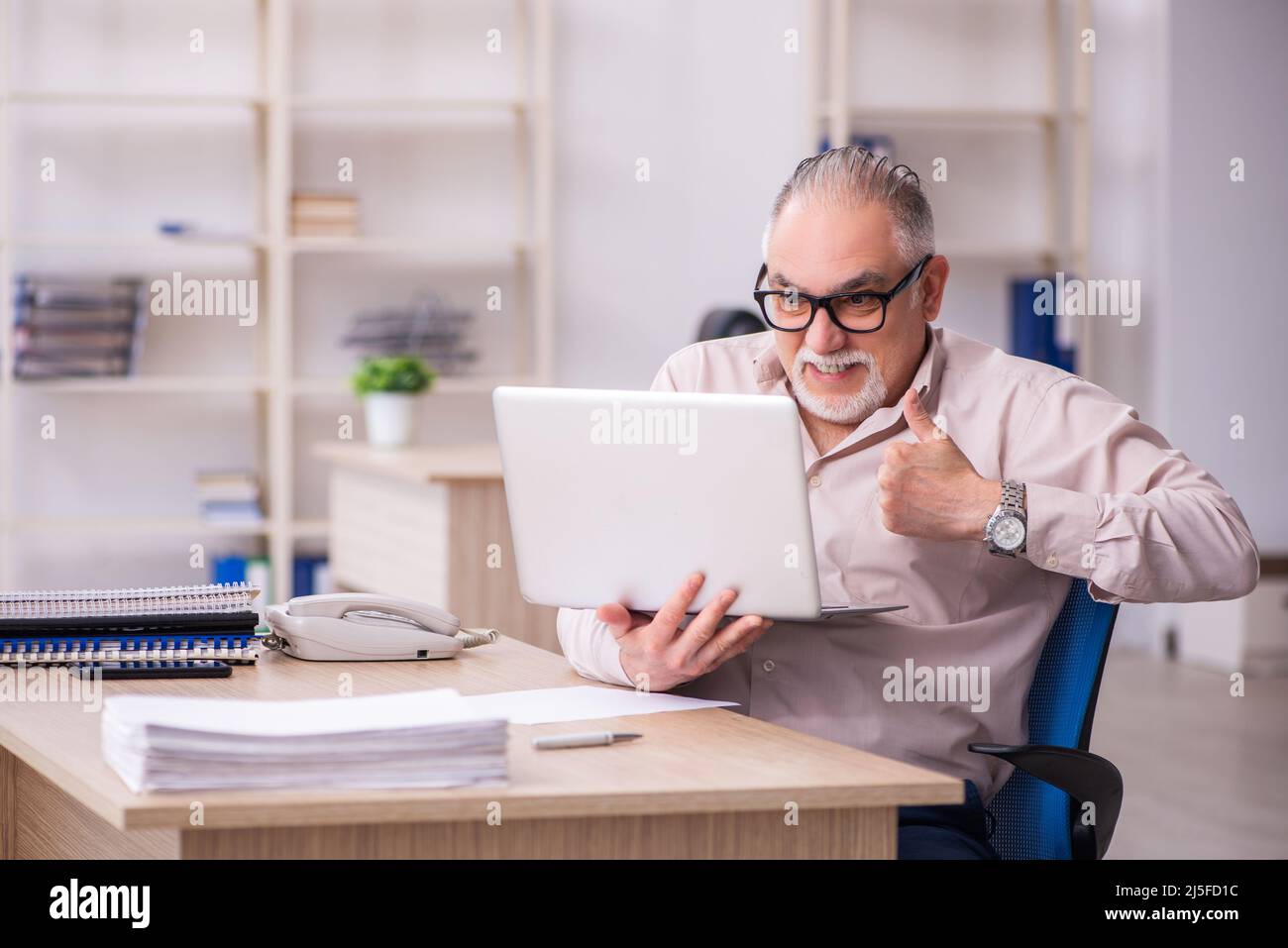 Old businessman employee working at workplace Stock Photo - Alamy