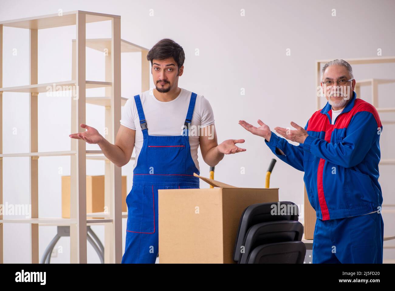 Two professional movers doing home relocation Stock Photo - Alamy