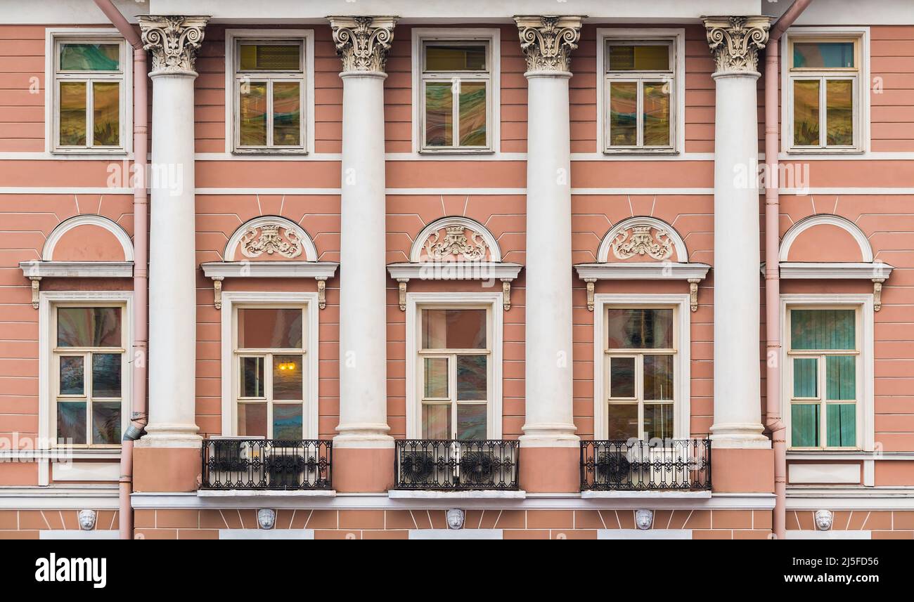 Columns and many windows in a row on the facade of the urban historic ...