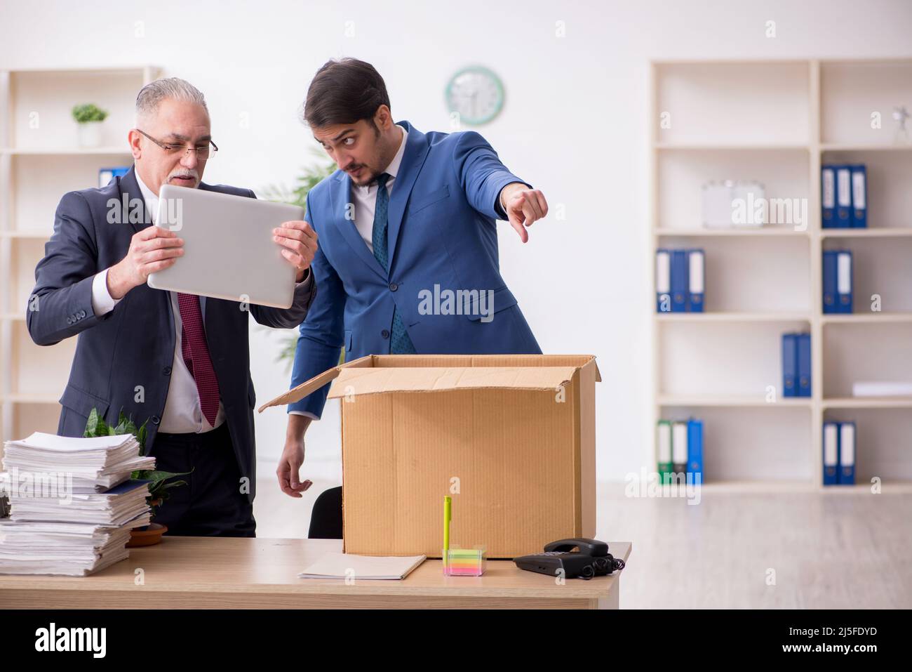Two employees in dismissal concept Stock Photo - Alamy