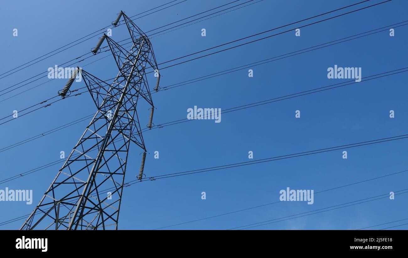 View of electricity pylon against deep blue sky with copy space Stock ...
