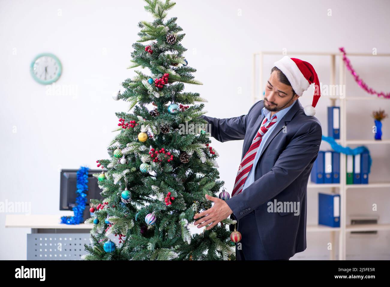 Young employee celebrating Christmas in the office Stock Photo - Alamy