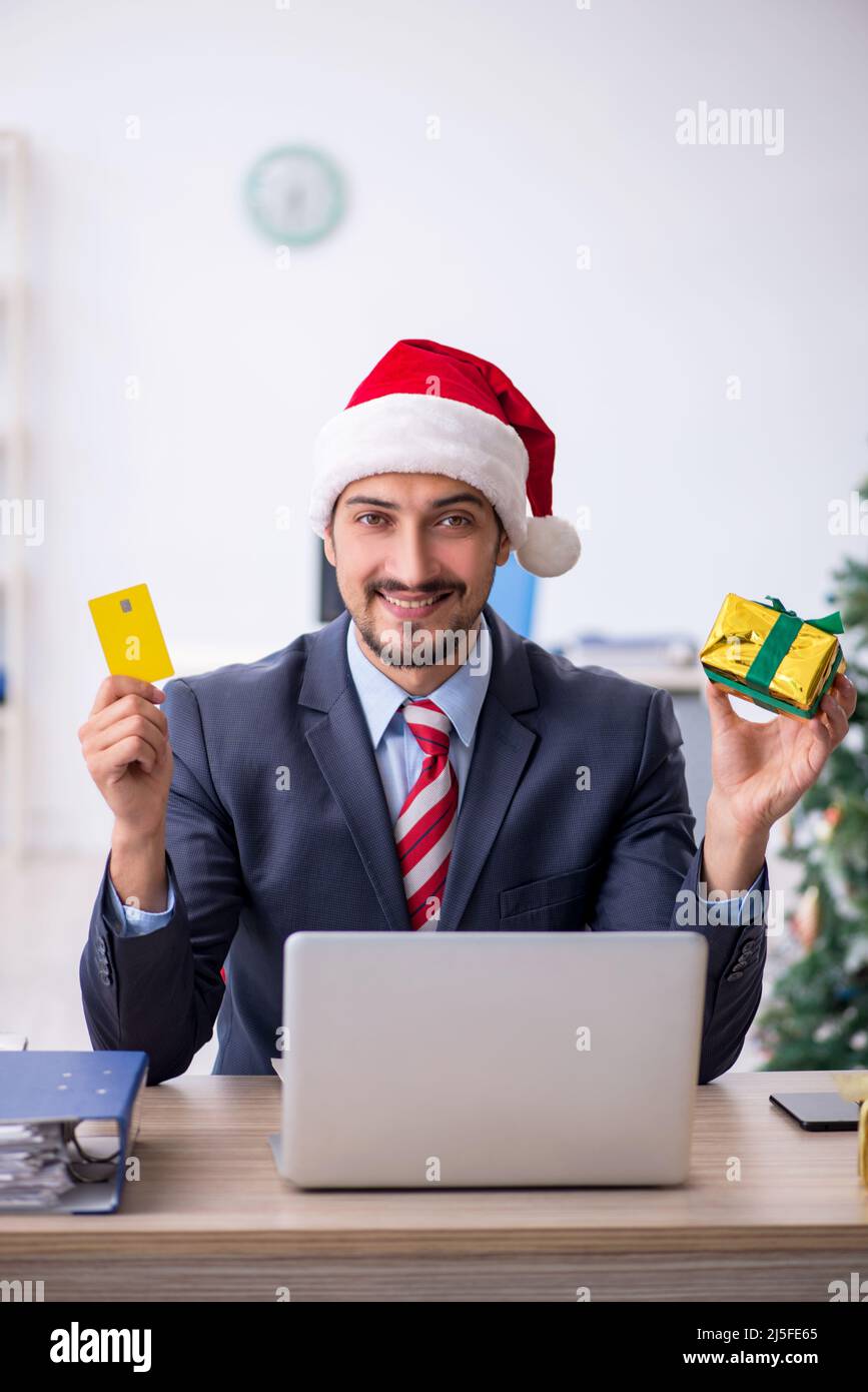 Young employee celebrating Christmas in the office Stock Photo - Alamy