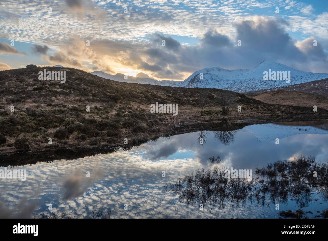 Gorgeous Winter sunset landscape image across Loch Ba in Scottish ...