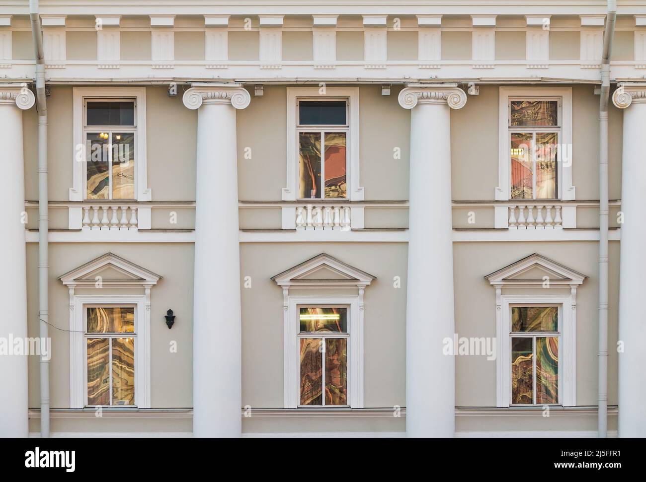 Columns and several windows in a row on the facade of the urban ...