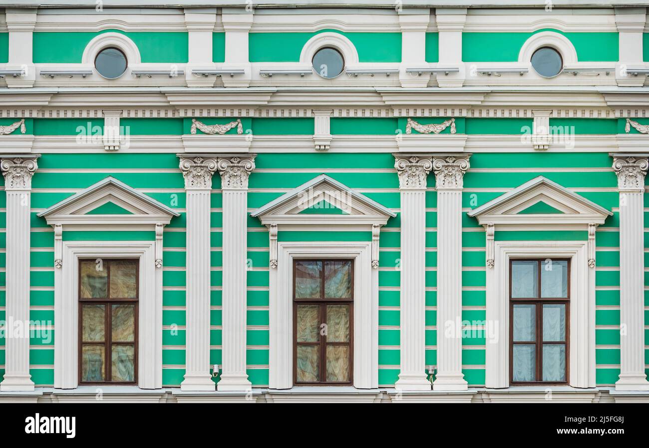 Several pilasters and windows in a row on the facade of the urban ...