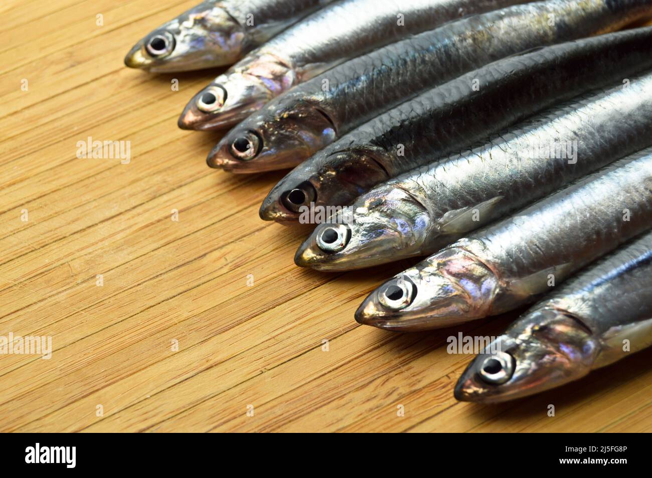 Cleaned and ready to cook fresh fish hamsi, anchovy concept on cutting ...