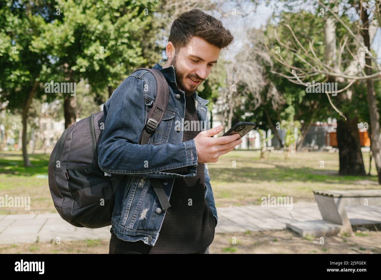 Handsome student standing texting hi-res stock photography and images ...