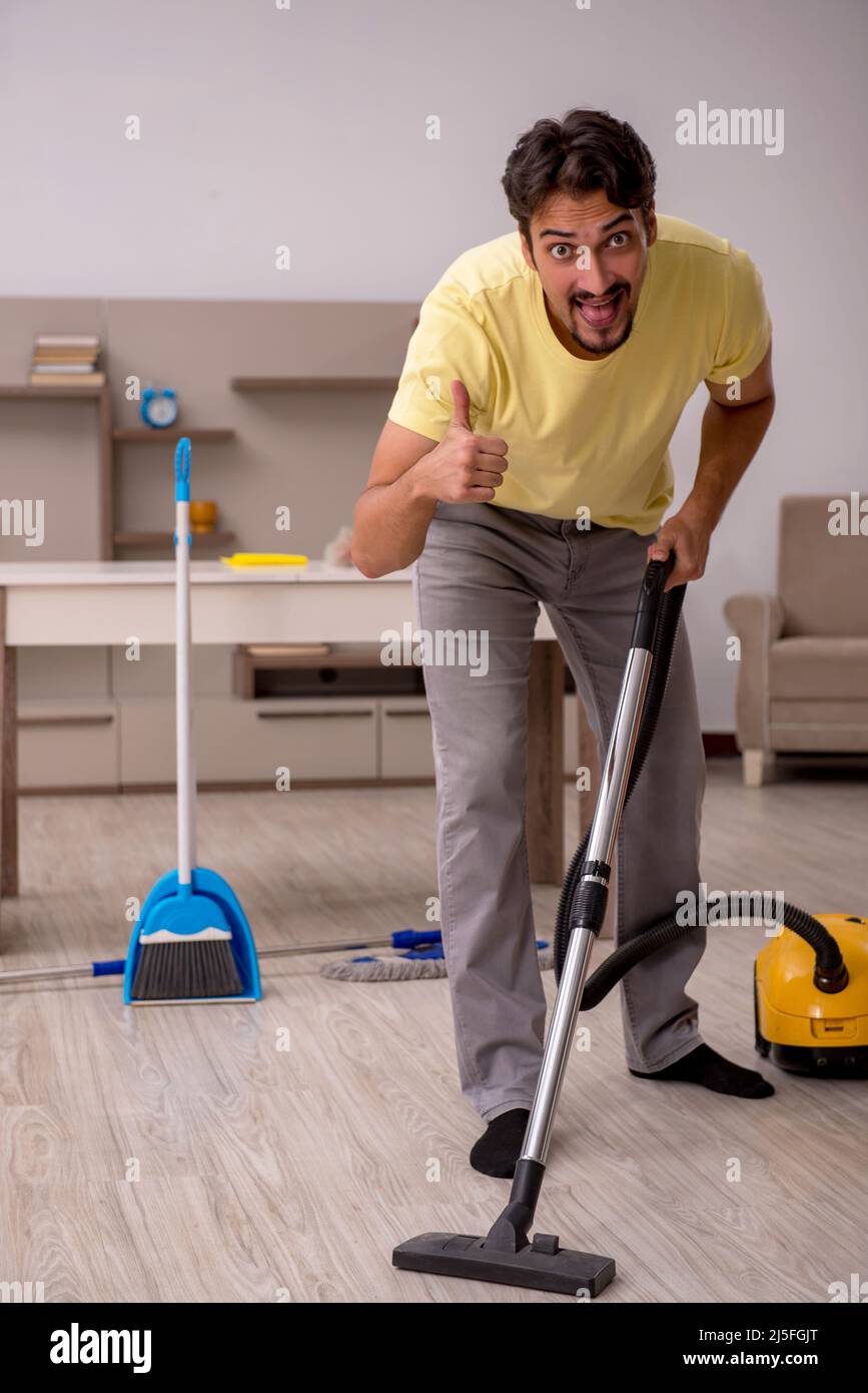 Young man cleaning the house Stock Photo - Alamy
