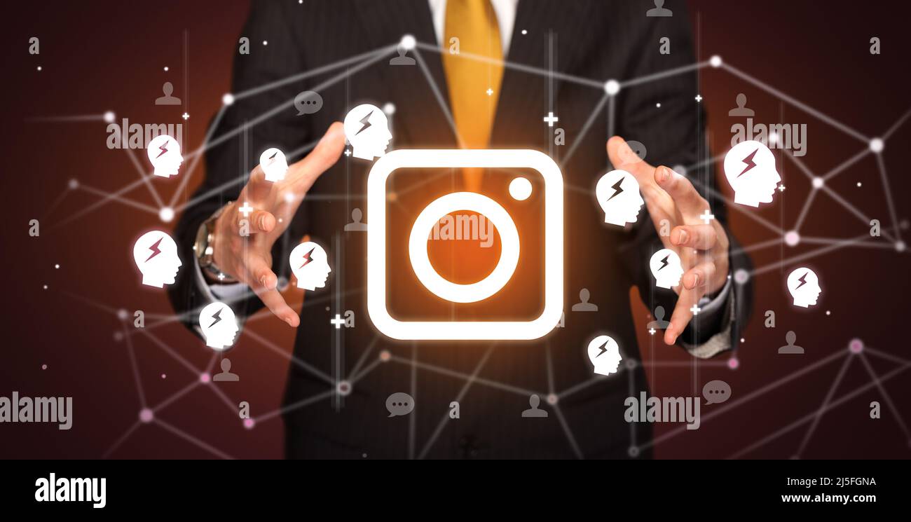 Hand holding social media icons Stock Photo - Alamy
