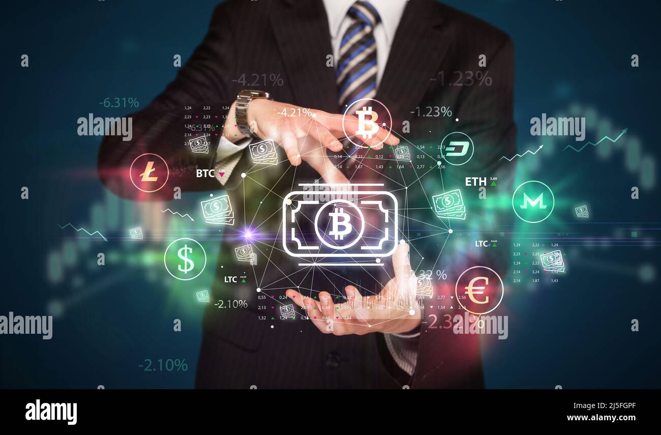 Businessman holding currency symbols concept Stock Photo - Alamy