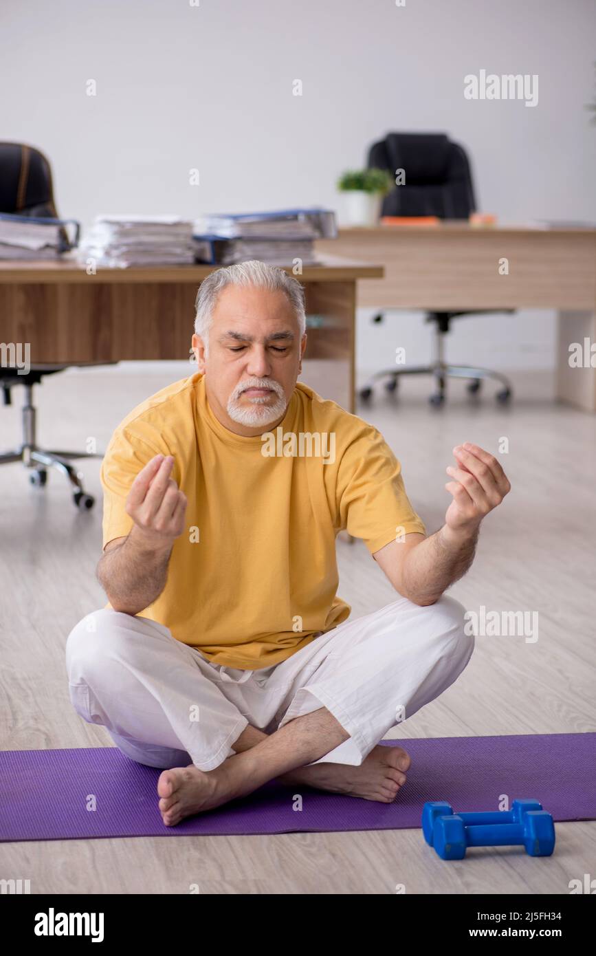 Old boss doing sport exercises during break Stock Photo - Alamy