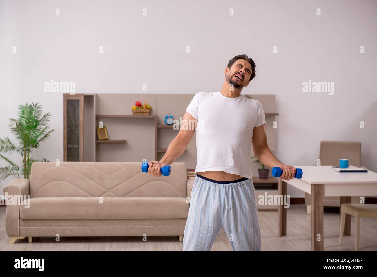 Young man doing sport exercises in the morning Stock Photo - Alamy