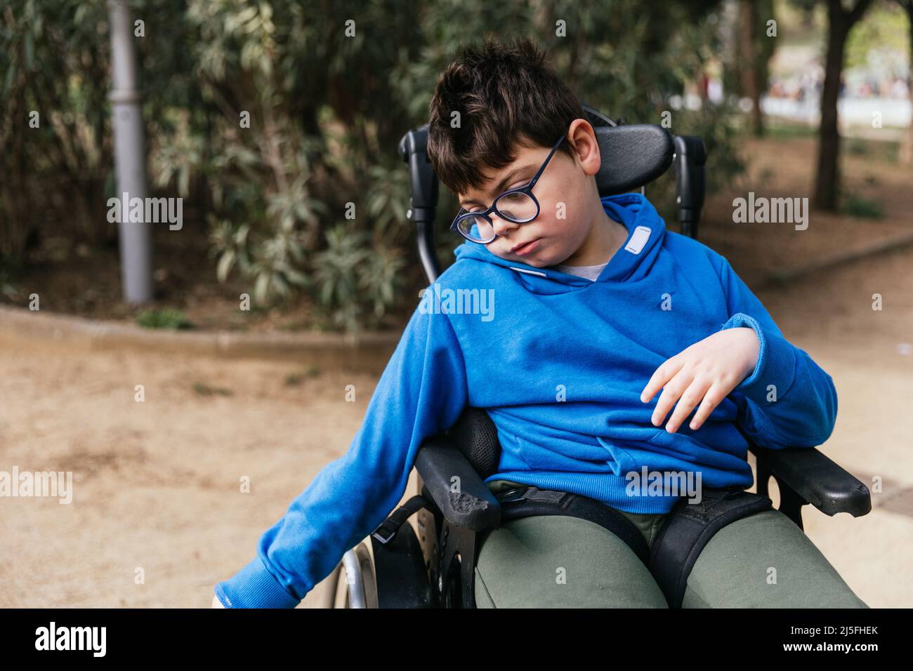 Child with multiple disabilities in a wheelchair enjoying the day ...