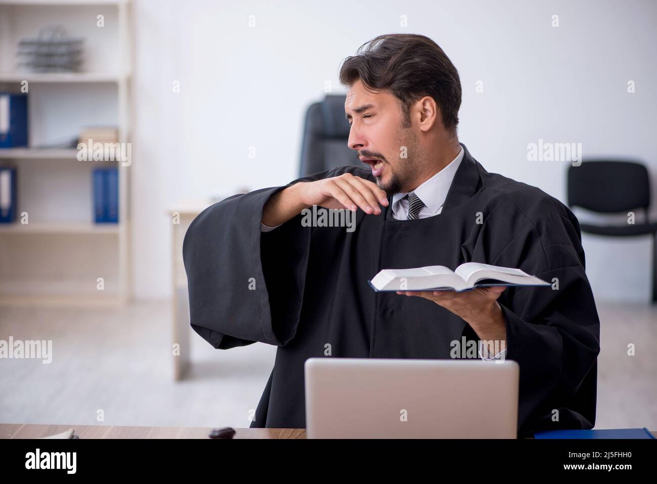 Young judge reading book in the courthouse Stock Photo - Alamy