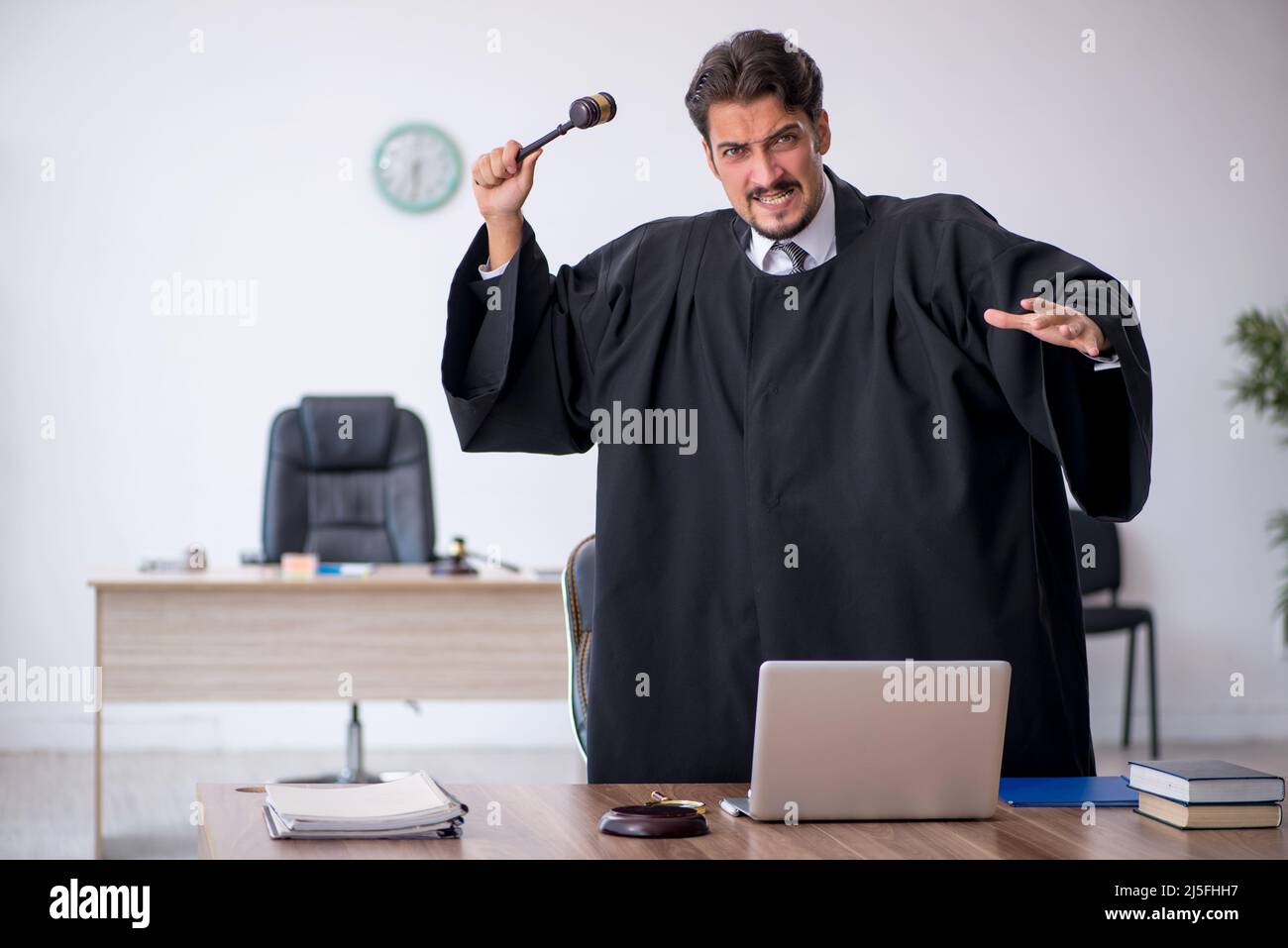 Young judge working in the courthouse Stock Photo - Alamy
