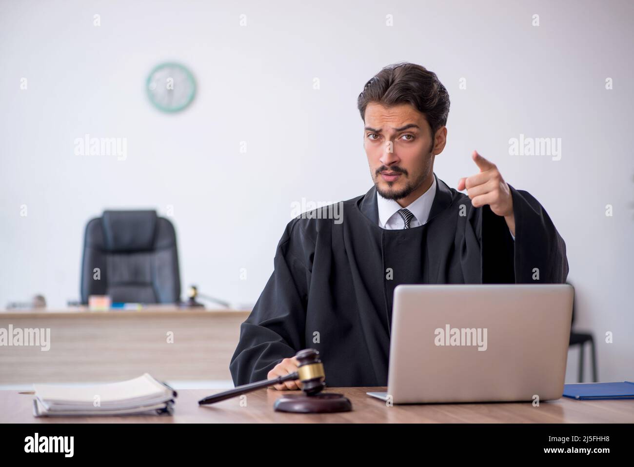 Young judge working in the courthouse Stock Photo - Alamy