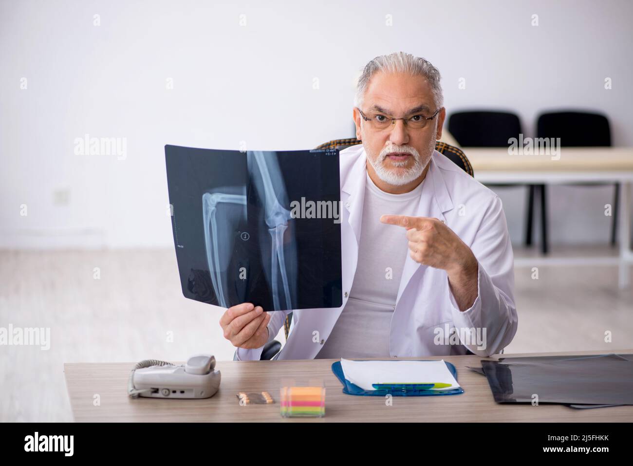 Old male doctor radiologist working at the hospital Stock Photo - Alamy