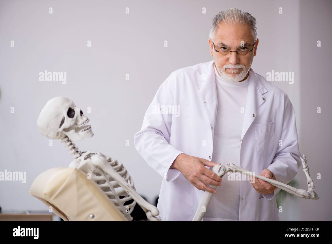 Old doctor with skeleton at the hospital Stock Photo - Alamy