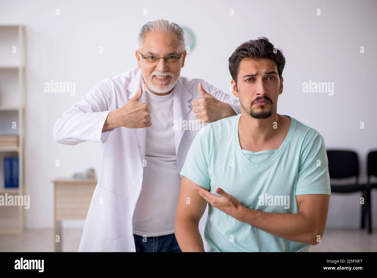 Young patient visiting old doctor Stock Photo - Alamy